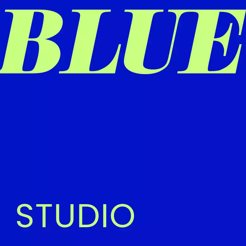 A simple storefront sign with blue and white Blue Studio text and a ...